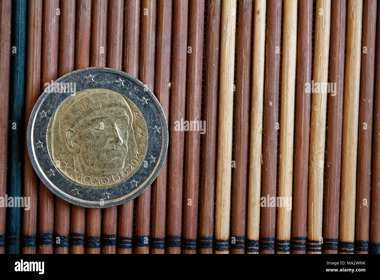 One euro coin lie on wooden bamboo table Denomination is 2 euro - back ...