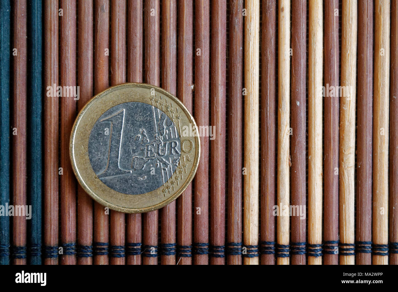 One euro coin lie on wooden bamboo table Denomination is 1 euro Stock ...