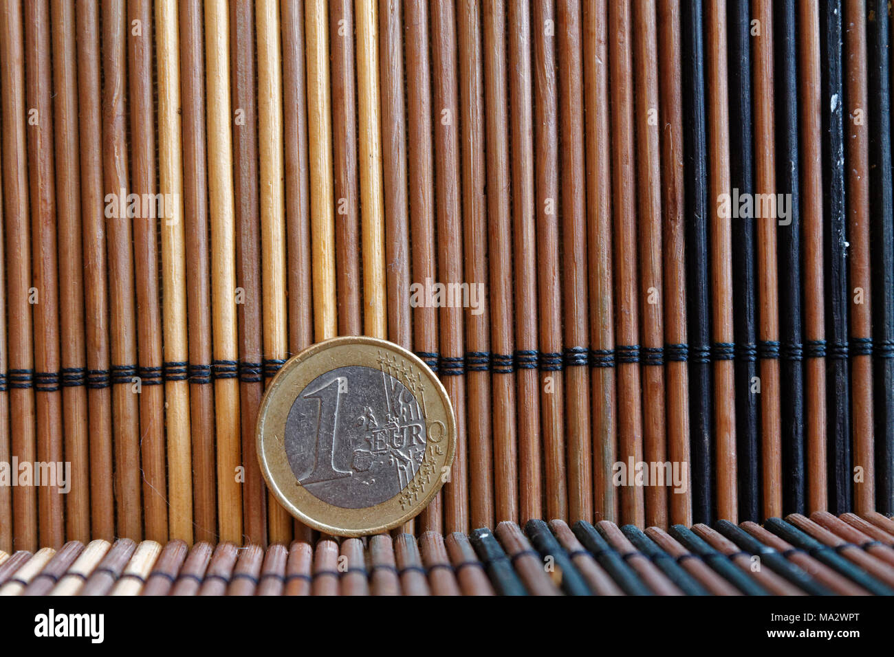 One euro coin lie on wooden bamboo table Denomination is one euro Stock ...
