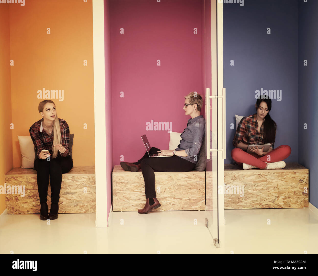 group of young business people having fun, relaxing and working in ...