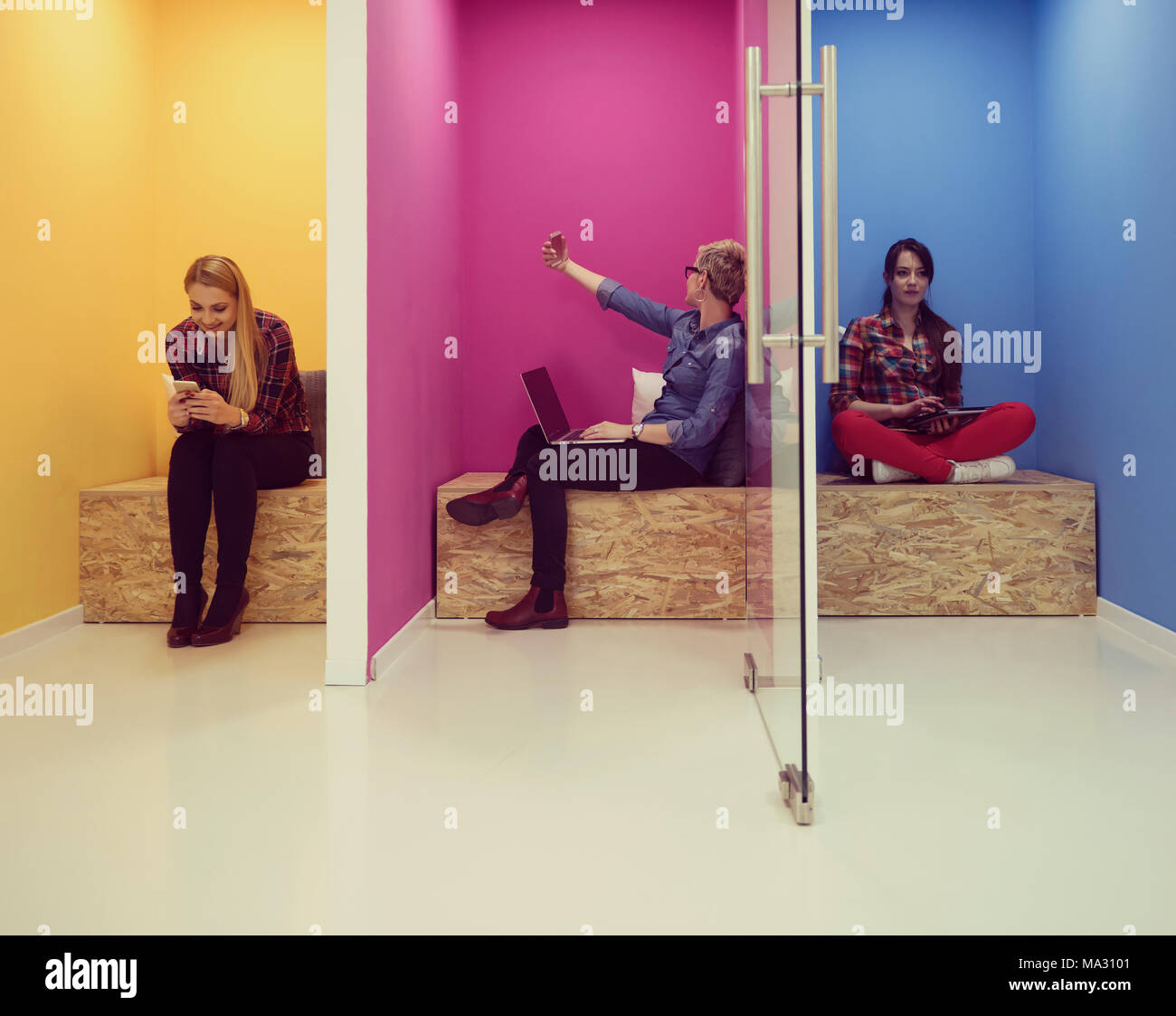 group of young business people having fun, relaxing and working in ...