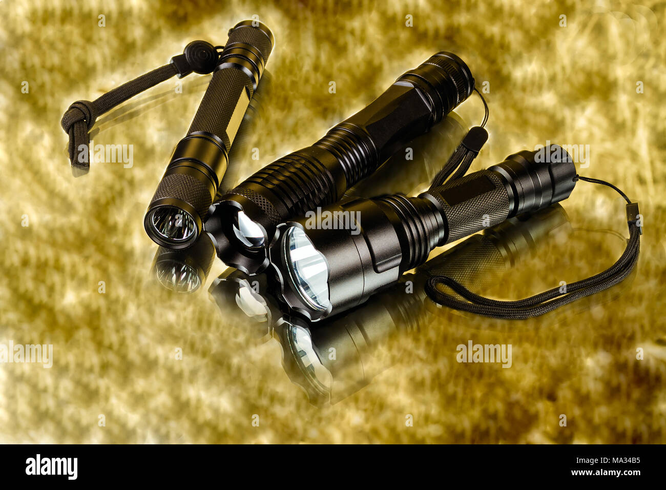 black anodized aluminium waterproof tactical flashlight on dark ...