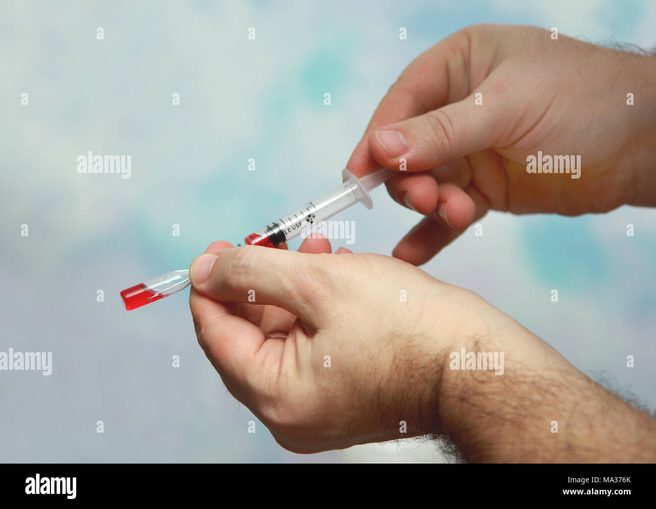 People gaining in a syringe medication red Stock Photo - Alamy
