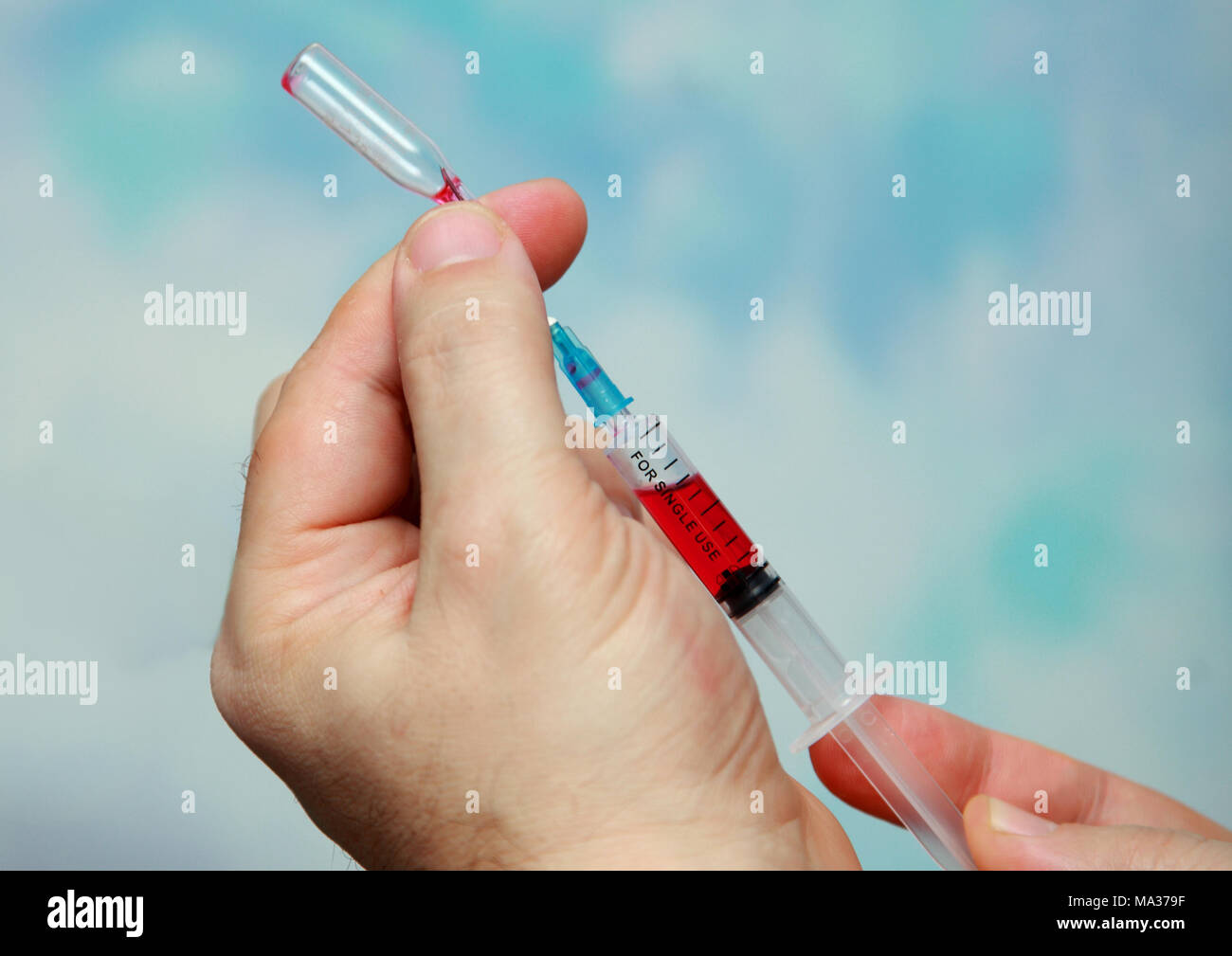Close-up of the hand of a person typing in a syringe medicine Stock ...