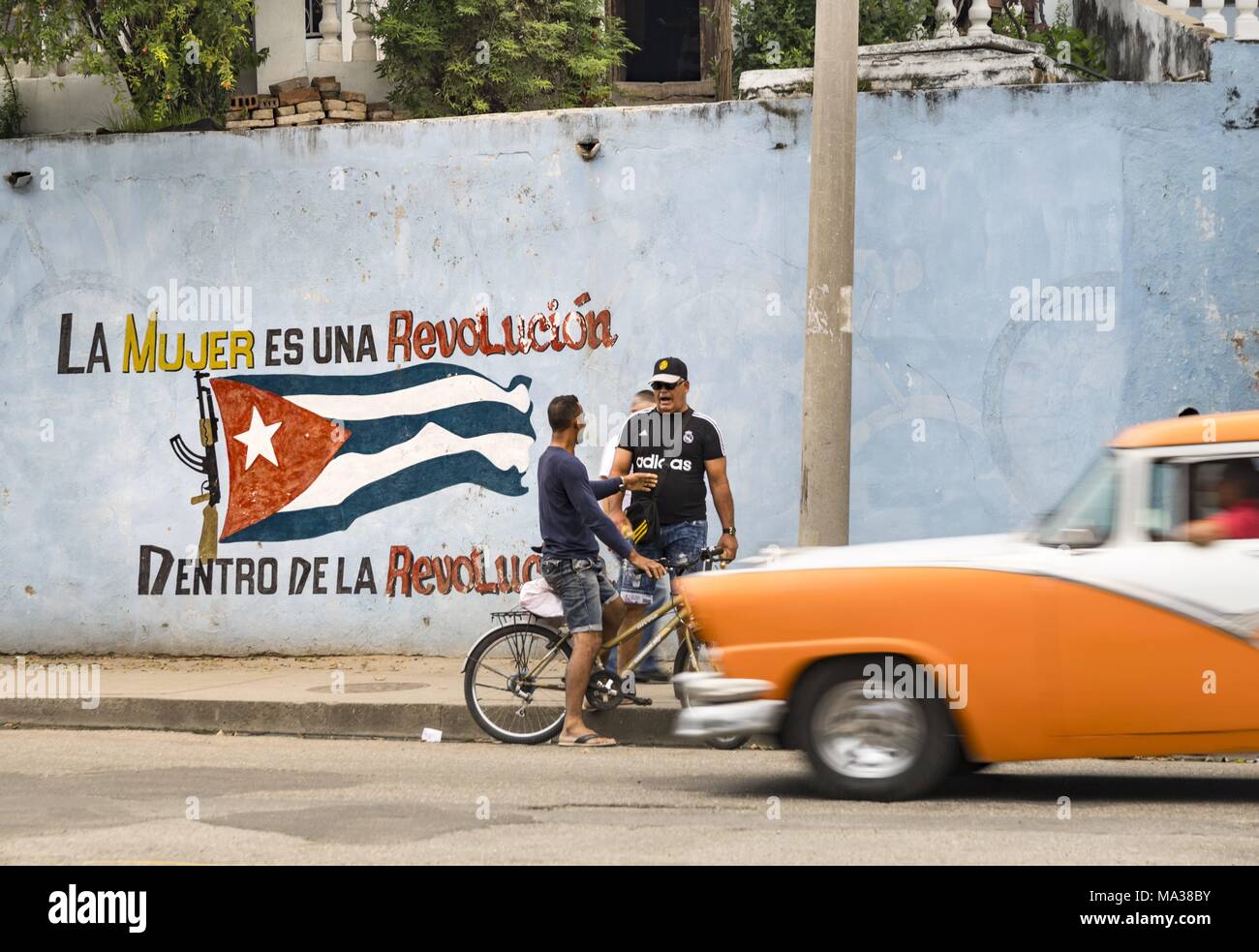 A wall on the roadside in Cienfuegos is painted with the Cuban national ...