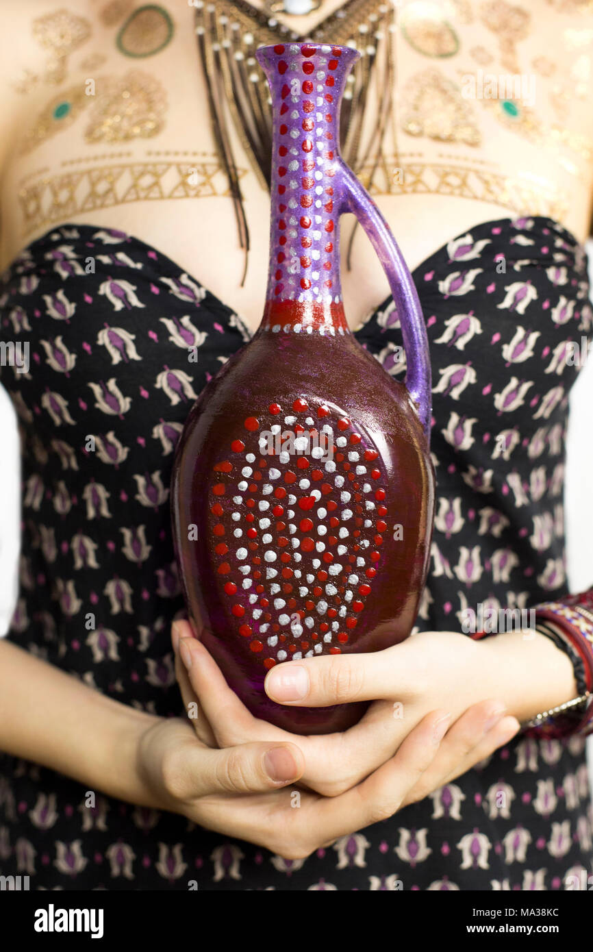 A beautiful girl in African style clothes is holding a pitcher Stock ...