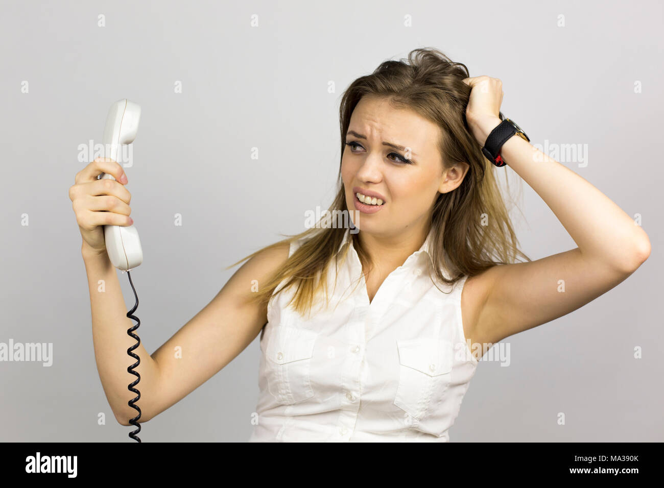 The girl is talking on the phone while on the face different emotions ...