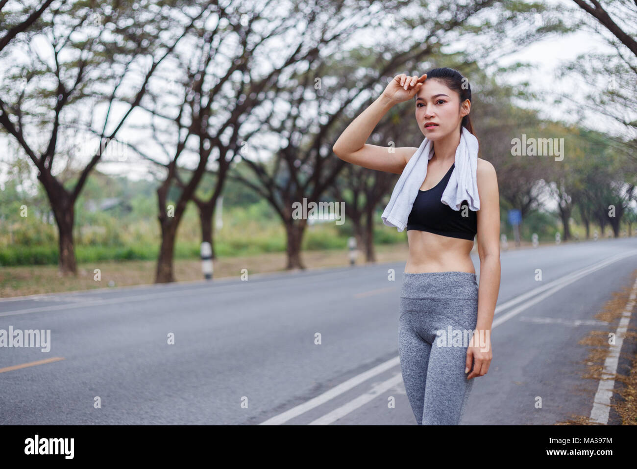 tired sporty woman after workout sport exercises outdoors at the park ...
