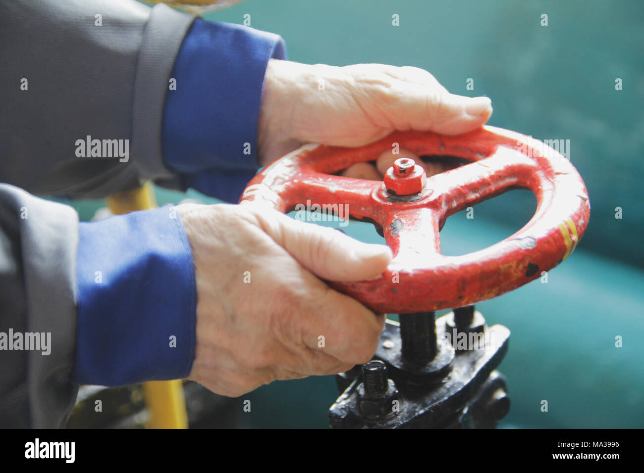 Hand of technician worker open the valve - close up Stock Photo - Alamy