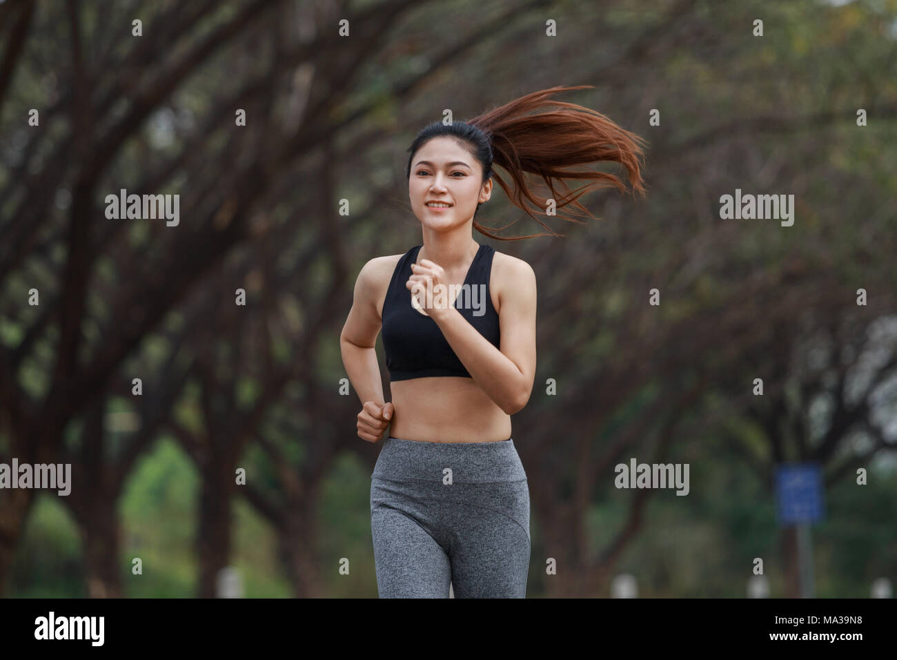 beautiful fitness woman running in the park Stock Photo - Alamy