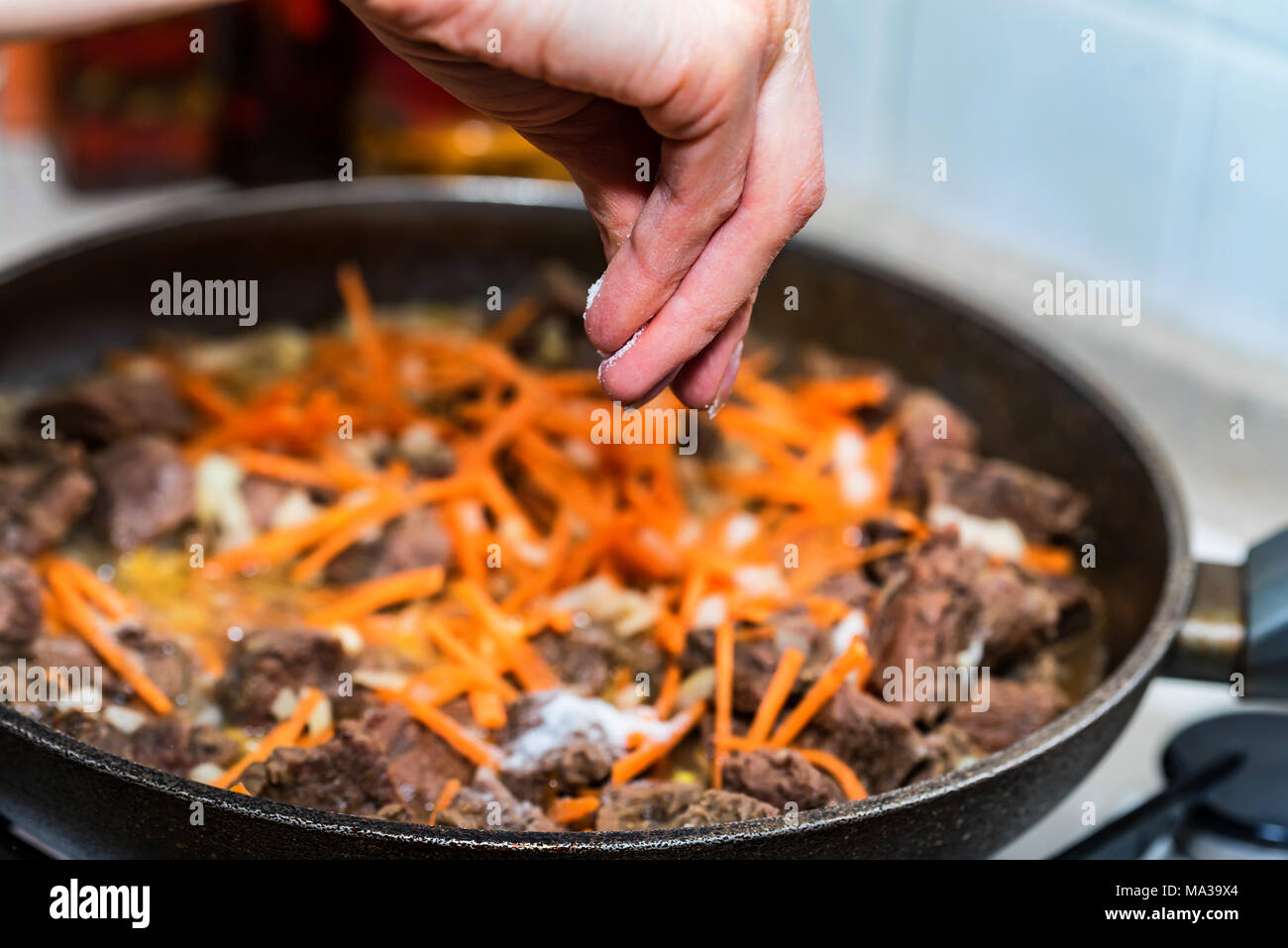 Adding salt on food hi-res stock photography and images - Alamy