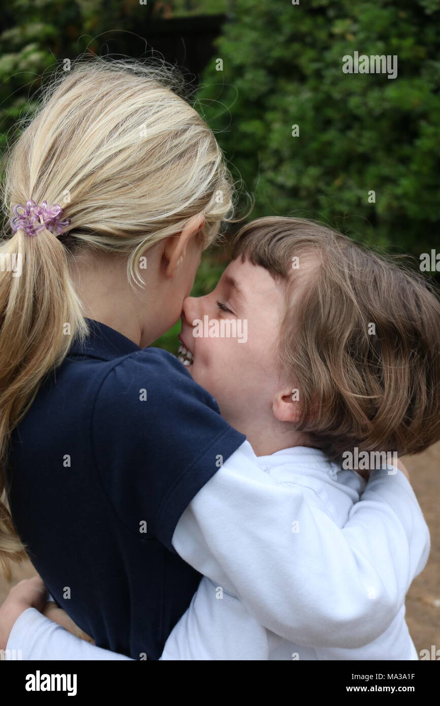 Two young sisters hugging Stock Photo - Alamy