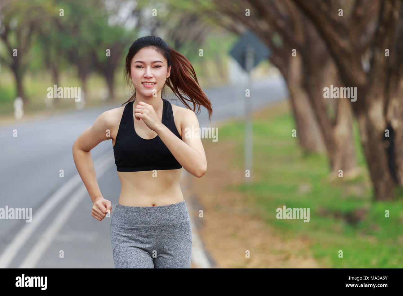 beautiful fitness woman running in the park Stock Photo - Alamy
