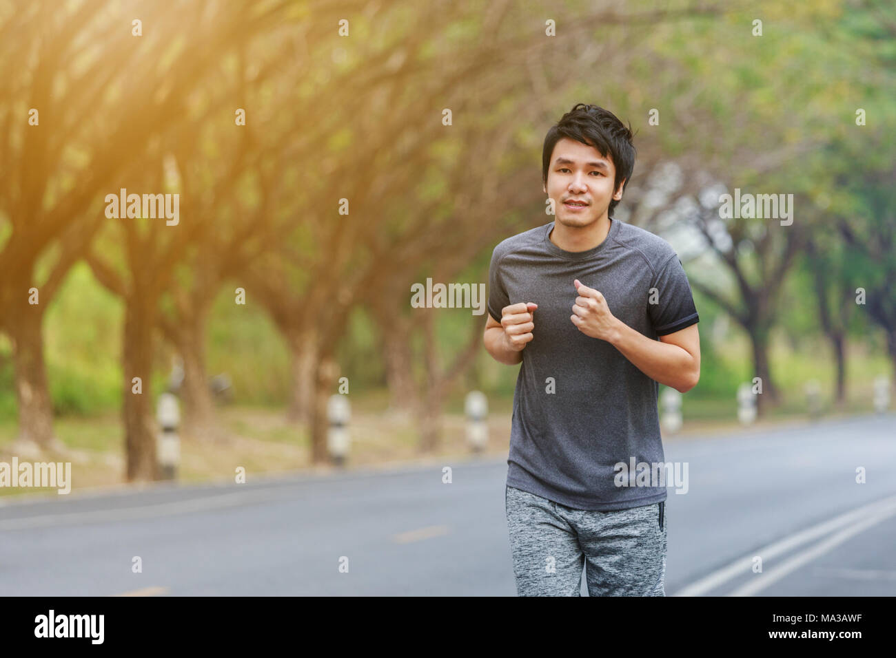 Young chinese man jogging in the park hi-res stock photography and ...