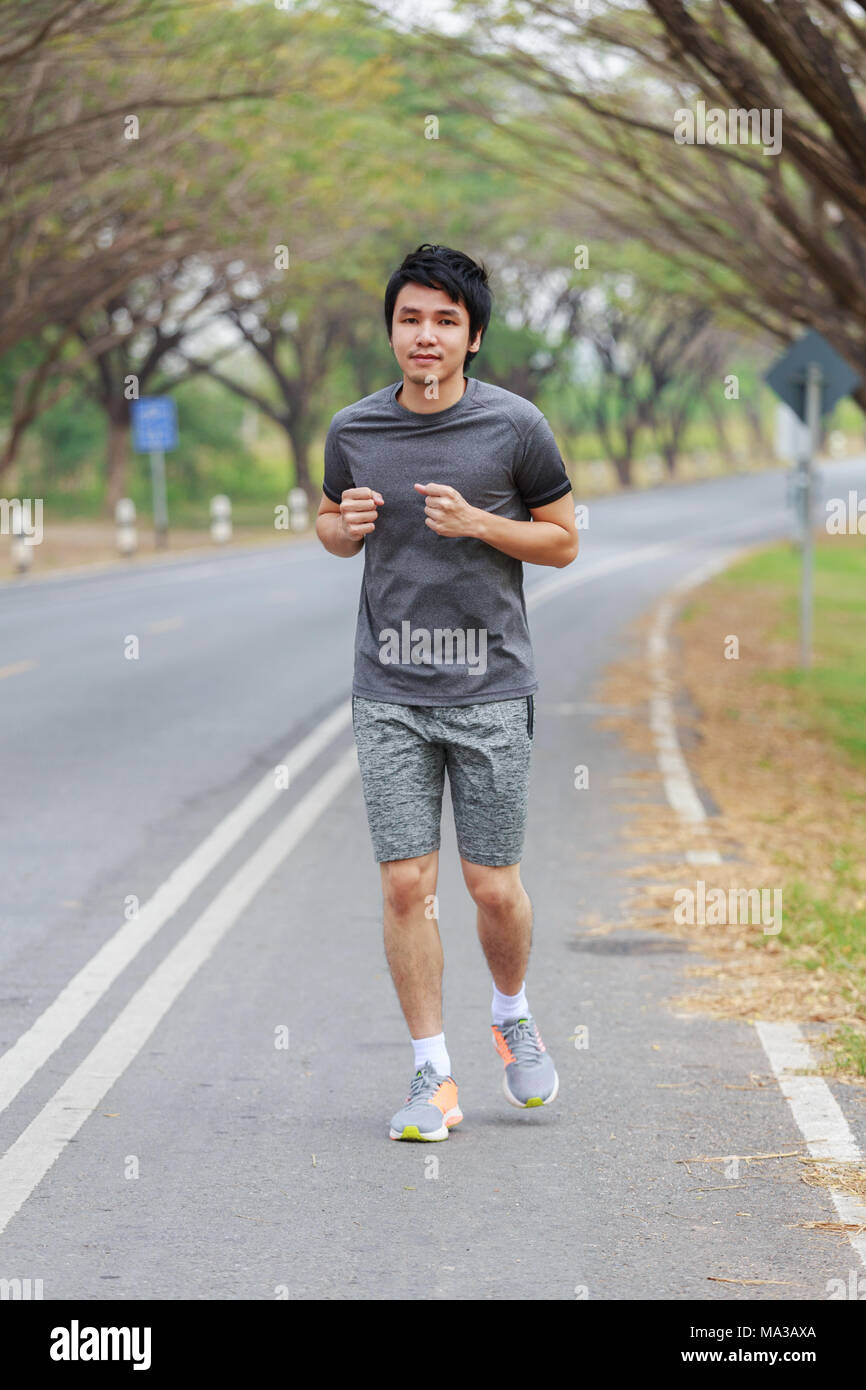 Young chinese man jogging in the park hi-res stock photography and ...