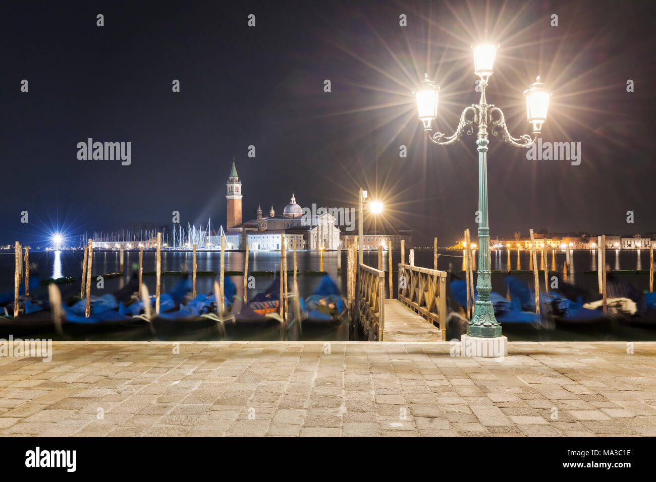 Gondolas dock, lamp post and San Giorgio Maggiore Church, Venice ...
