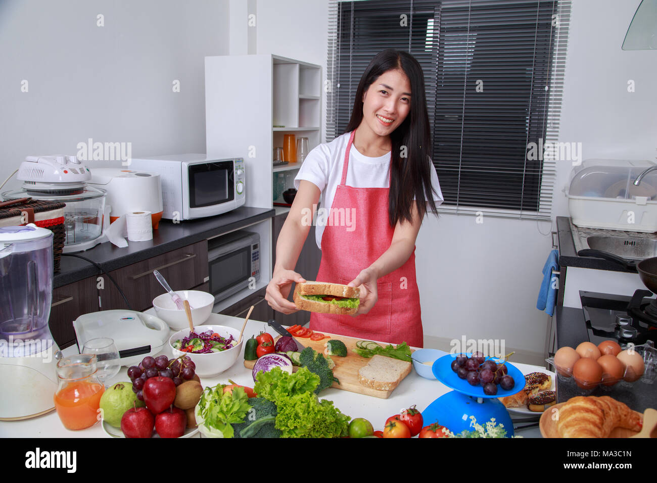 woman preparing a sandwich in kitchen room at home Stock Photo - Alamy