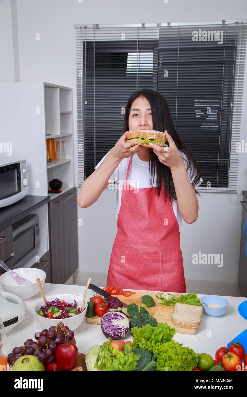 Asian woman eating sandwich hi-res stock photography and images - Alamy