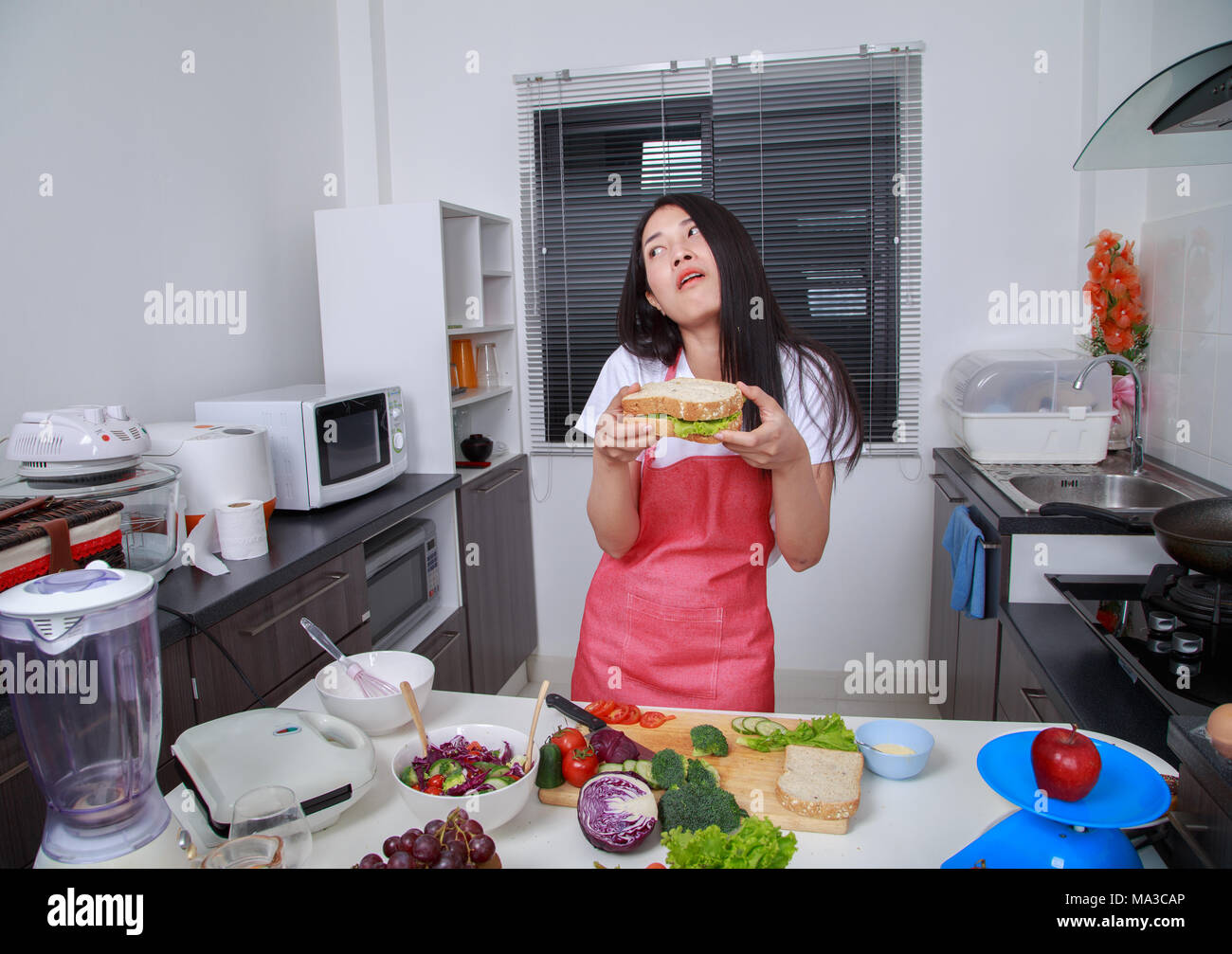 Girl holding sandwich home hi-res stock photography and images - Alamy