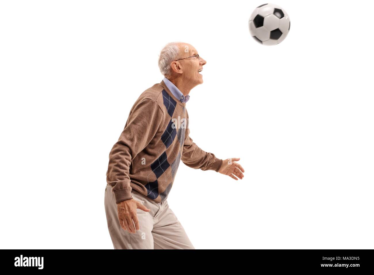 Elderly man heading a football isolated on white background Stock Photo ...