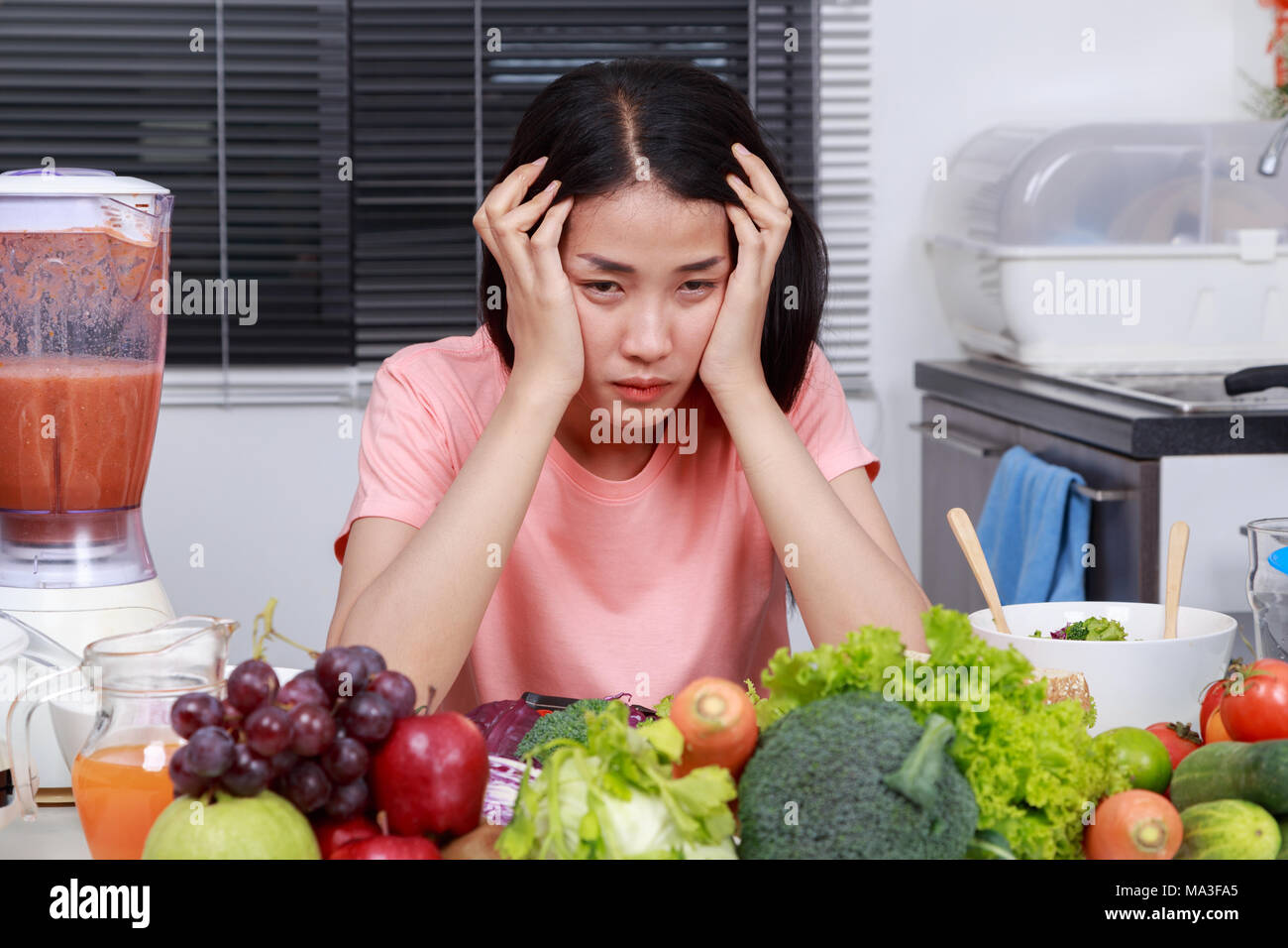 depressed young woman cooking in kitchen room Stock Photo - Alamy