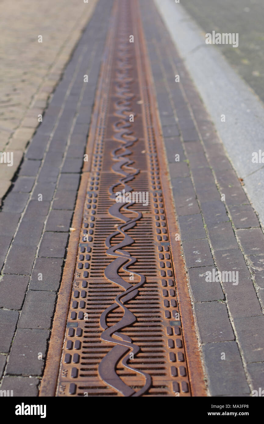 Wavy lines on a sewer grid Stock Photo - Alamy