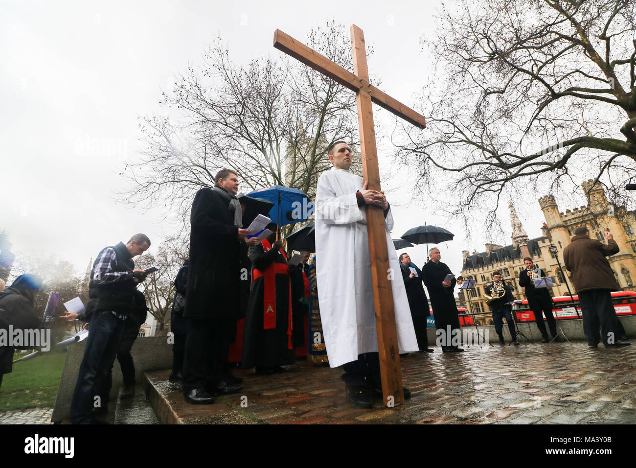 London, UK. 30th March 2018. Christian worshippers accomanied by clergy ...