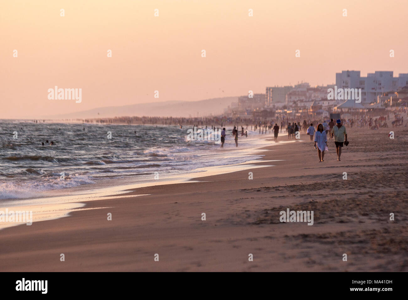 People walking during sunset in Matalascañas beach, Almonte, Huelva ...