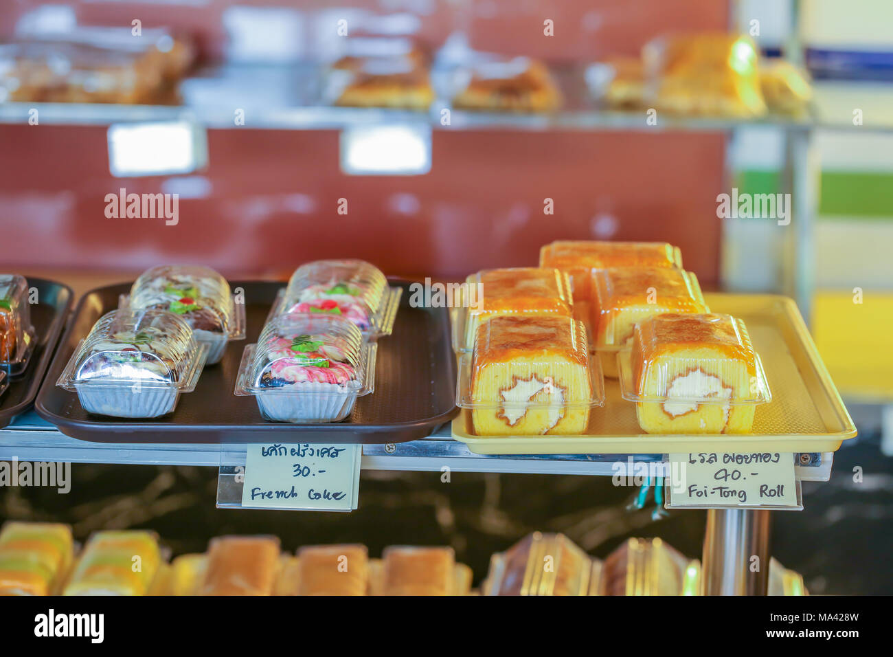 yam roll and cake on tray for sale in the cake shop Stock Photo - Alamy