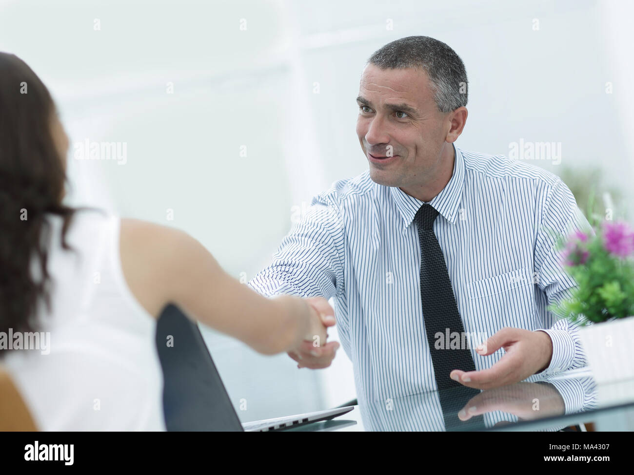 closeup.handshake Manager and client on the background of the office ...