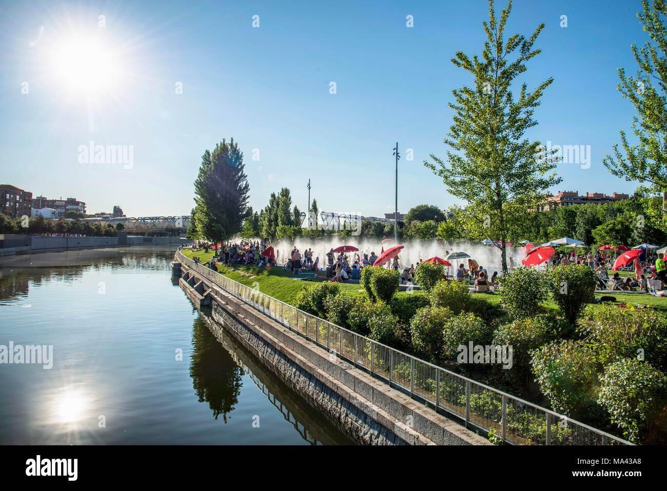 A landscaped green area with water features over the M30 motorway in ...