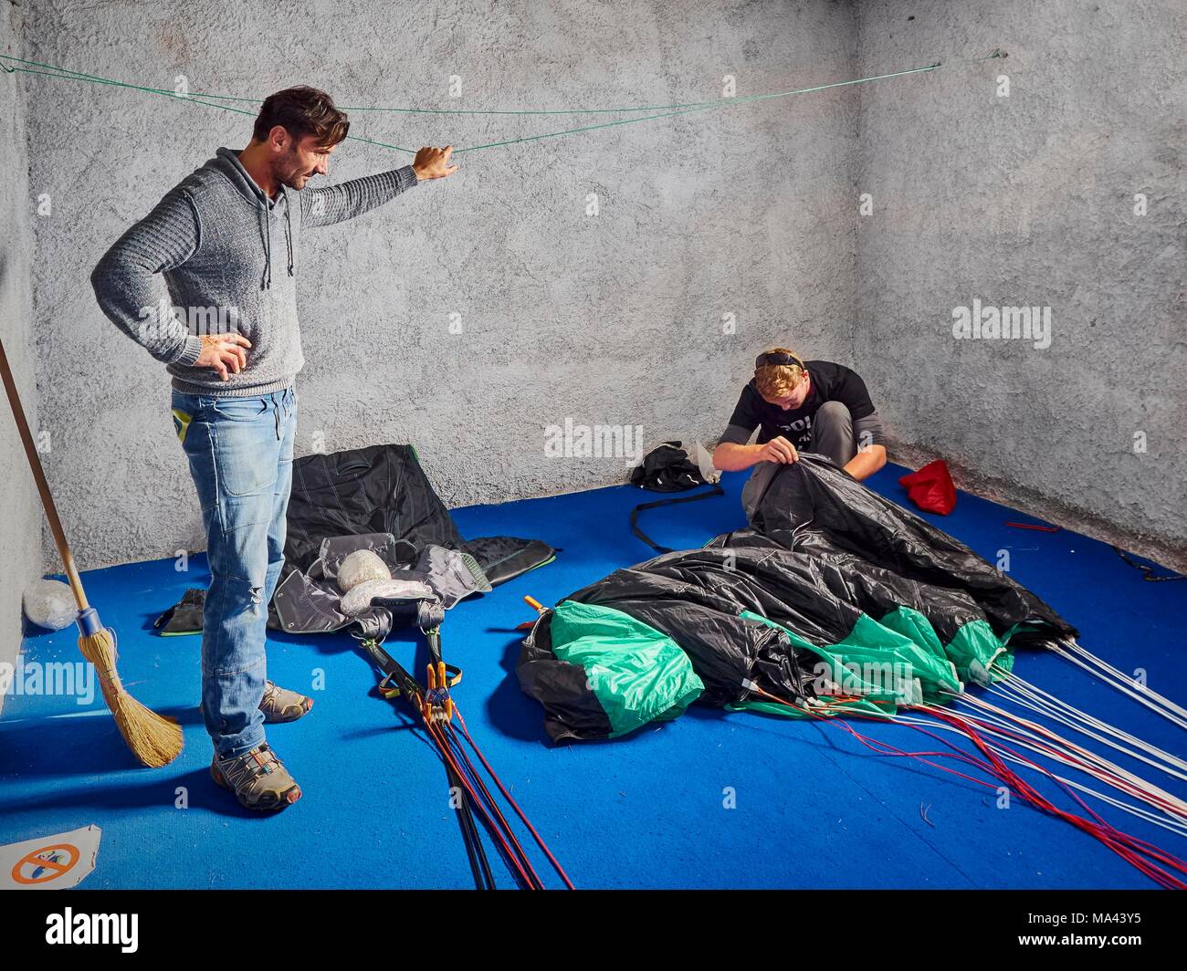 Man folding parachute hi-res stock photography and images - Alamy