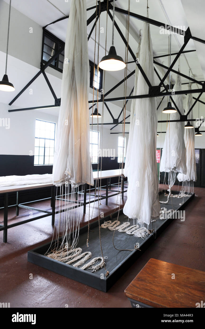 Parachutes hanging in hanger ready to pack Stock Photo - Alamy