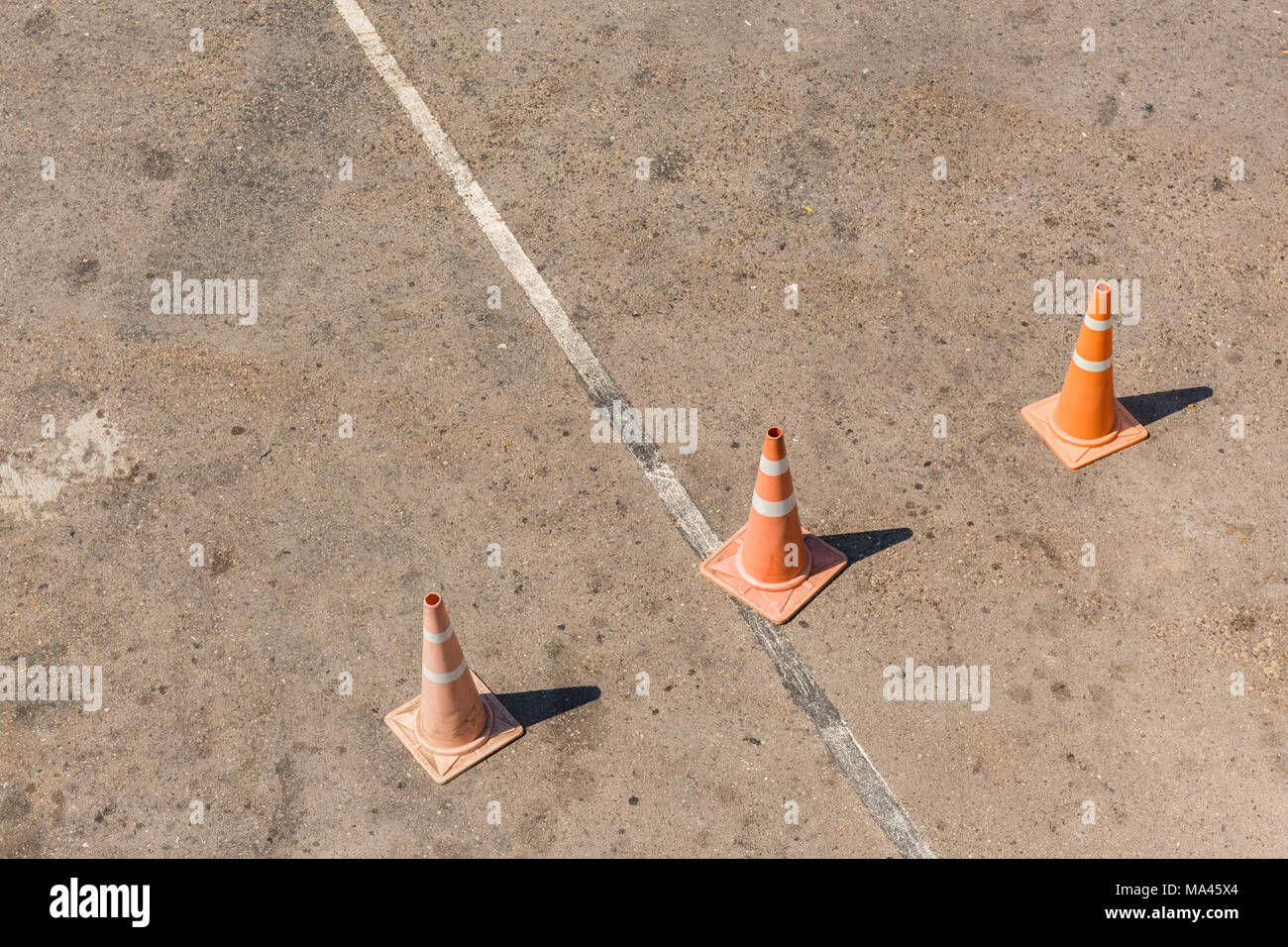 Three Orange road hazard cones Stock Photo - Alamy