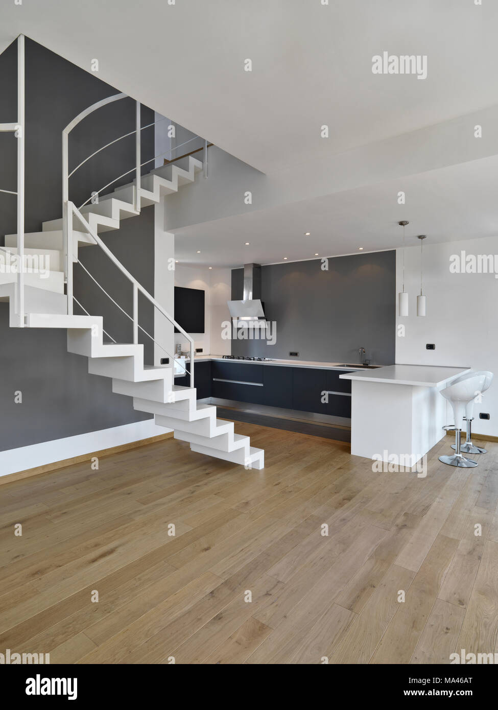 interiors shots of a modern kitchen with staircase and wooden flooting ...