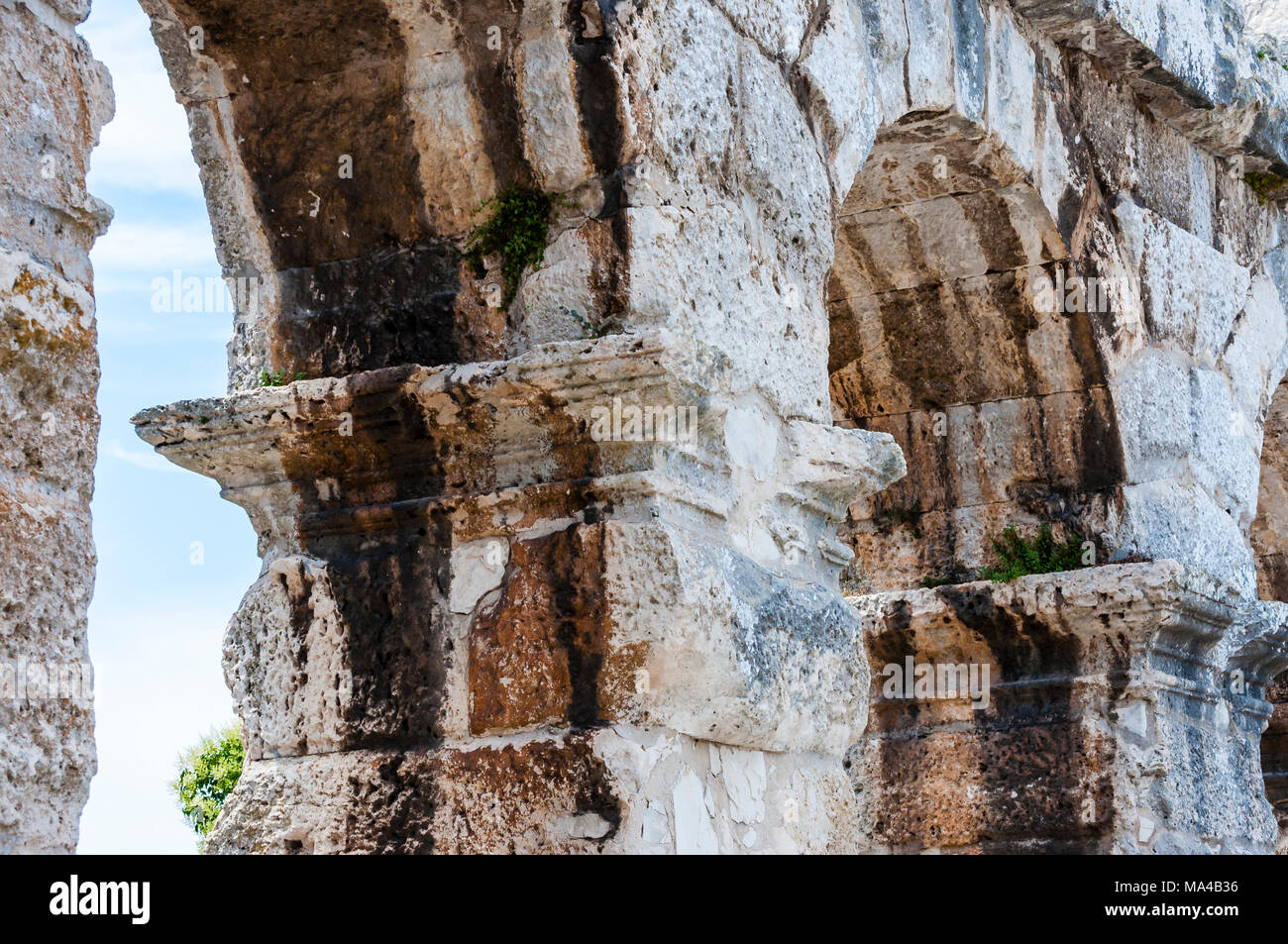 Ancient rows of arc columns in Pula CoWooden door in ancient medieval ...
