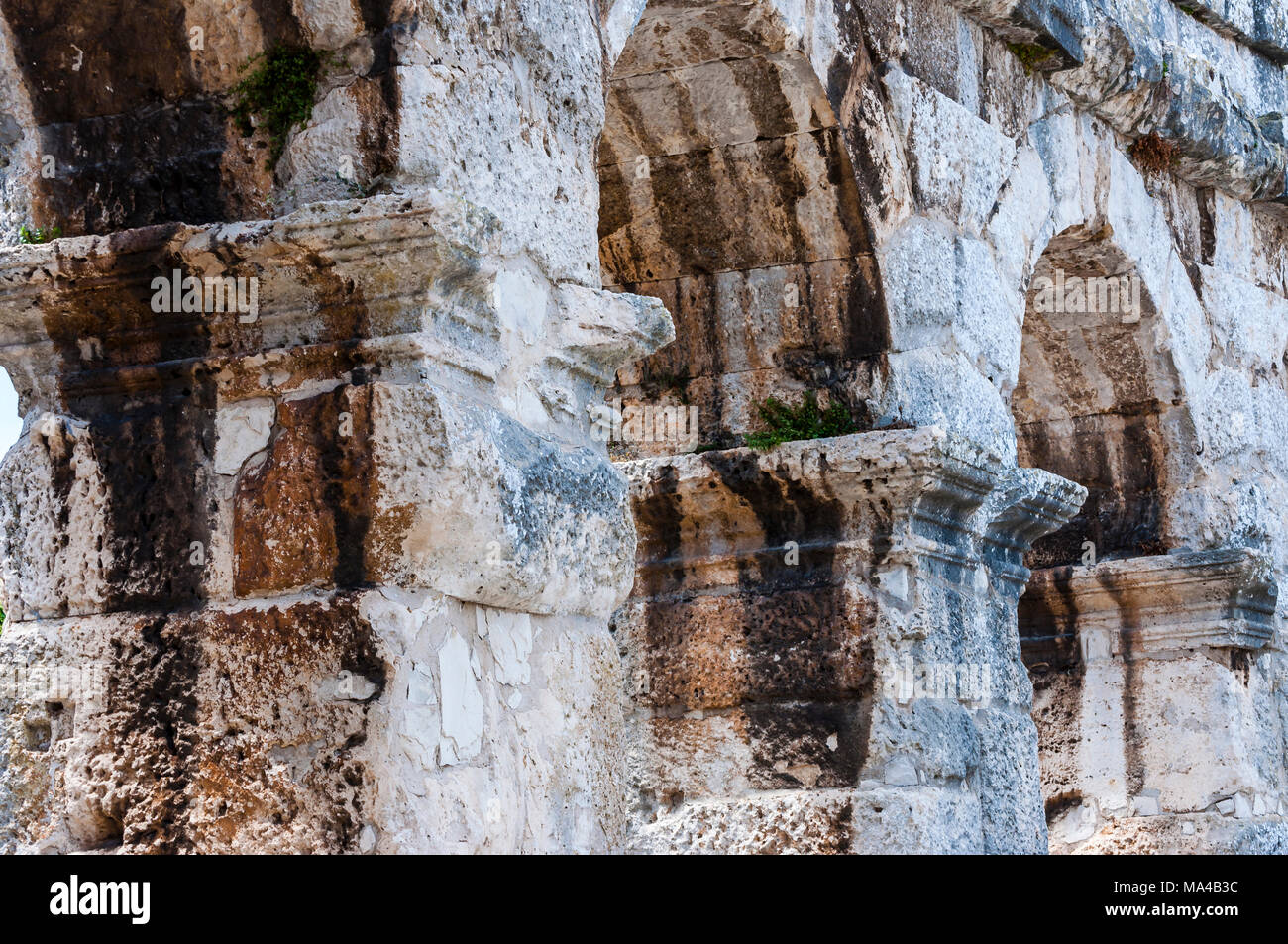 Ancient rows of arc columns in Pula Coliseum monument Stock Photo - Alamy