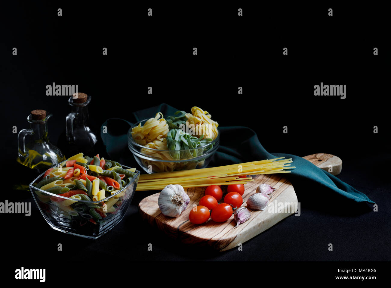 Chiaroscuro Dark Food Pasta ingredients with spaghetti, tagliatelle and ...