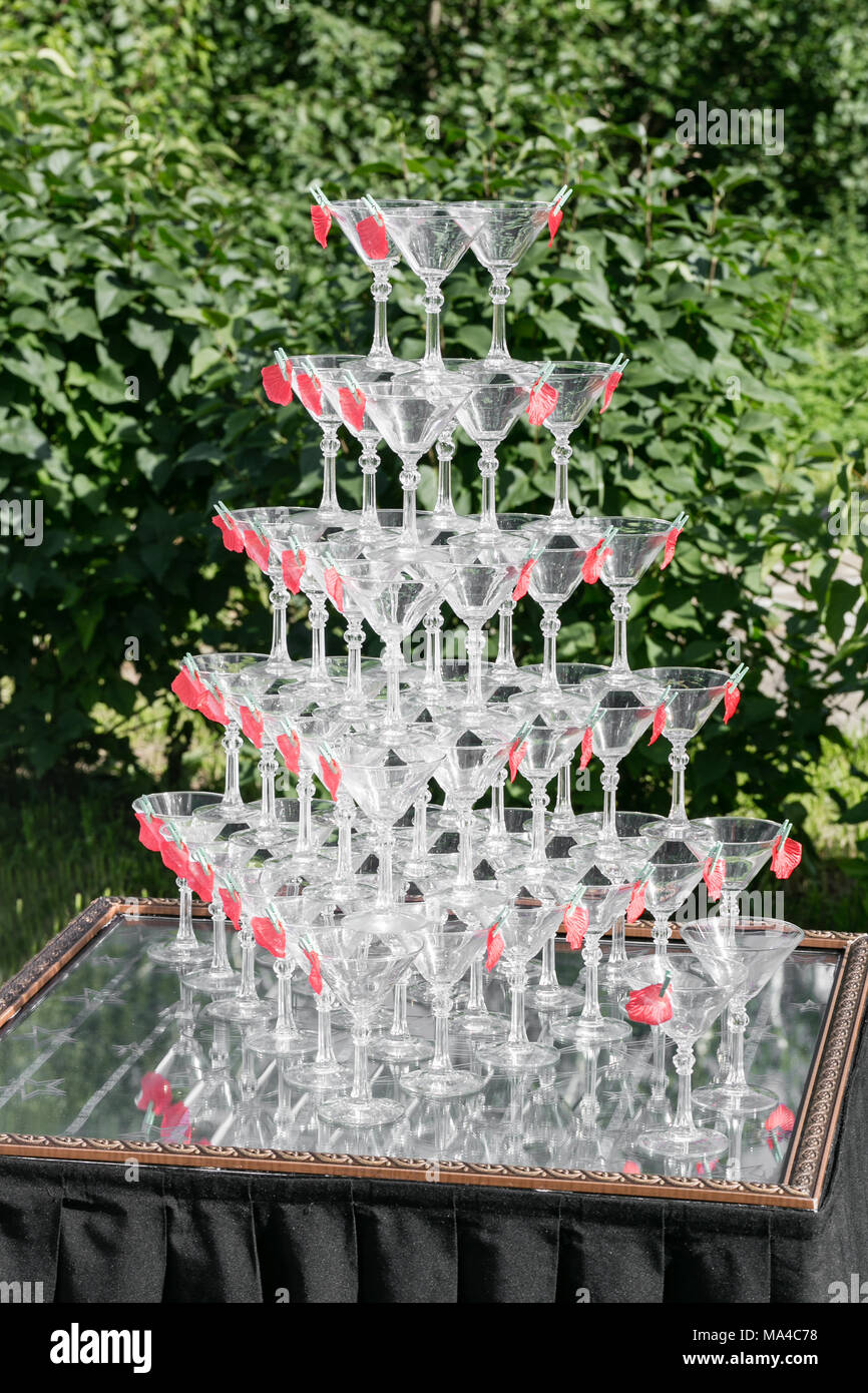 Champagne glass pyramid on wedding party. Tower of glasses of wine ...