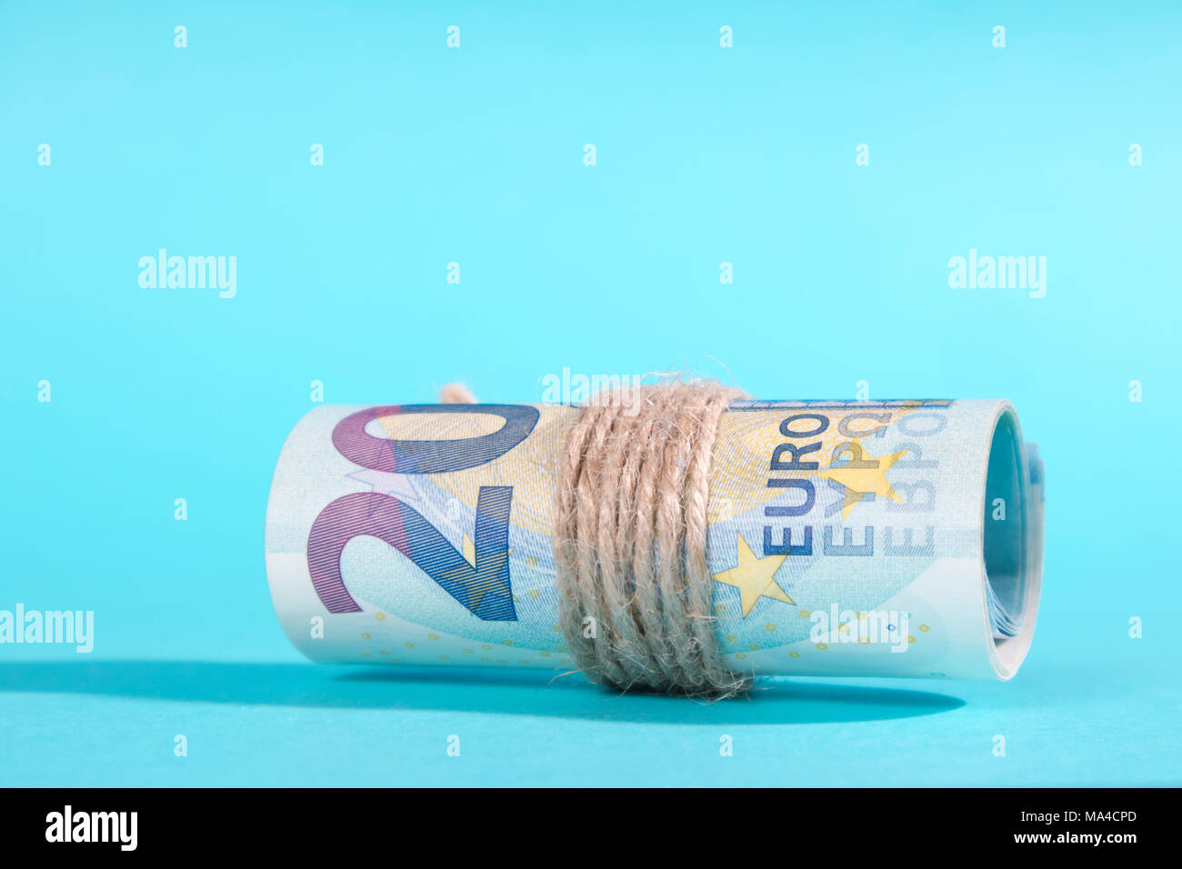 Twenty Euro Notes Rolled Over A Blue Background The Copy Space Stock twenty-euro-notes-rolled-over-a-blue-background-the-copy-space-stock