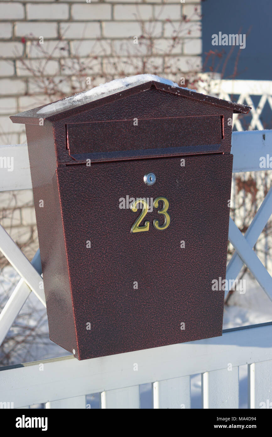 Mailbox hanging on a white plastic fence Stock Photo - Alamy