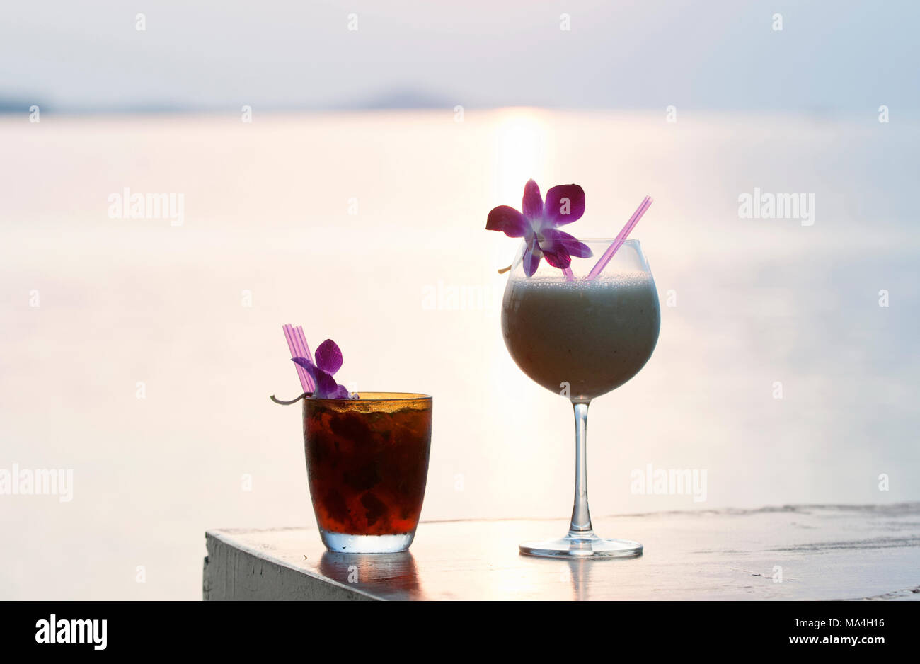 Coktails on the beach on sunset Stock Photo - Alamy