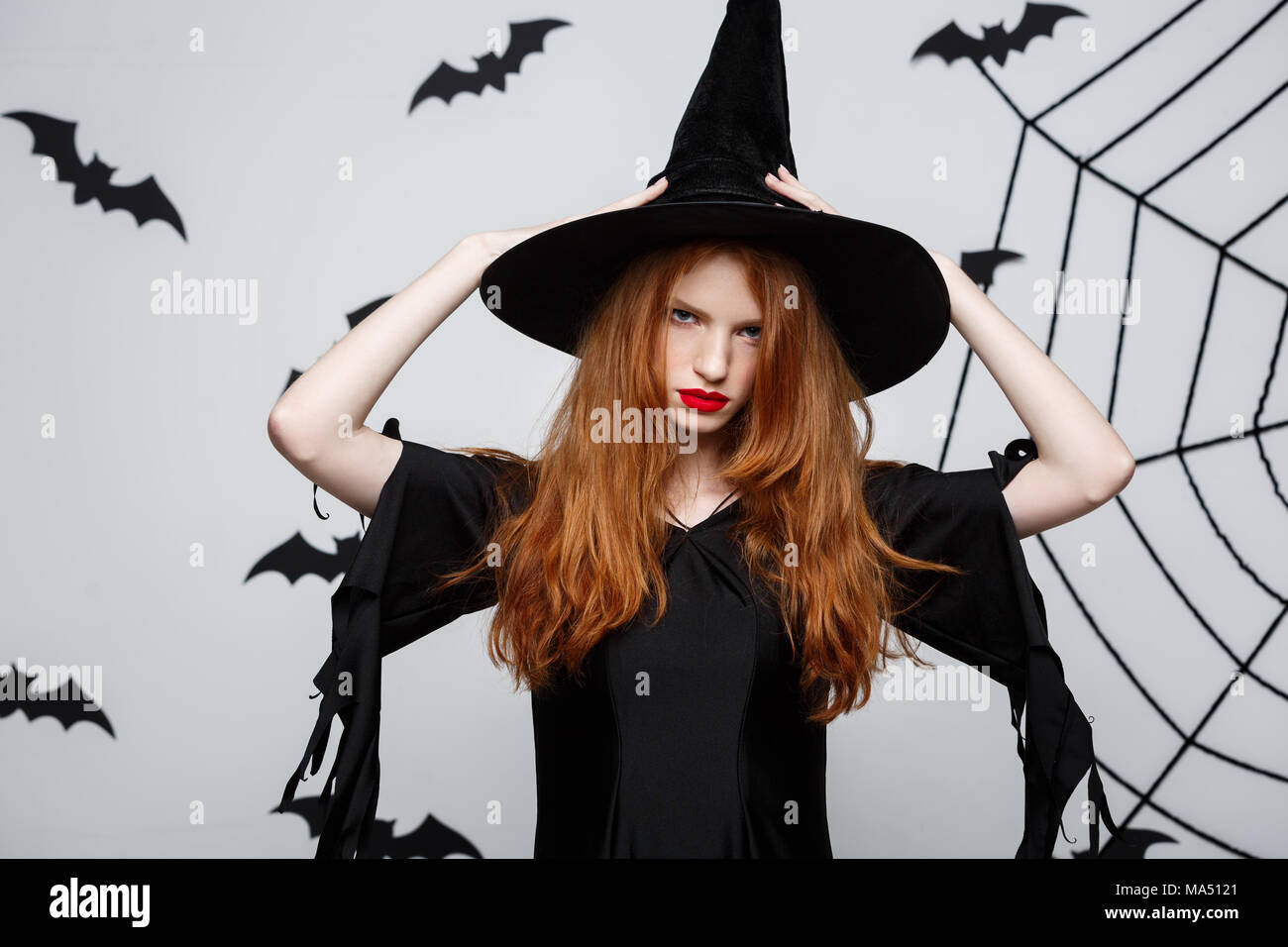 Halloween Concept - Beautiful serious witch with angry facial ...