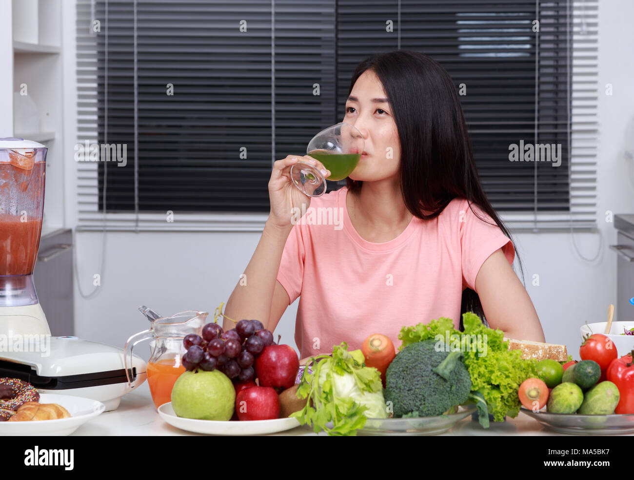 Young woman eating raw food juice hi-res stock photography and images ...