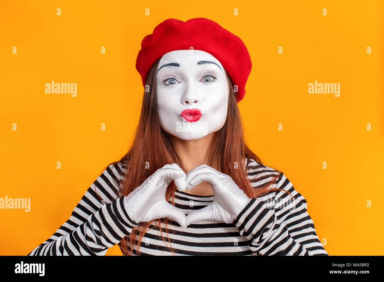 Closeup portrait of cute mime woman showing heart, love sign. Emotions ...