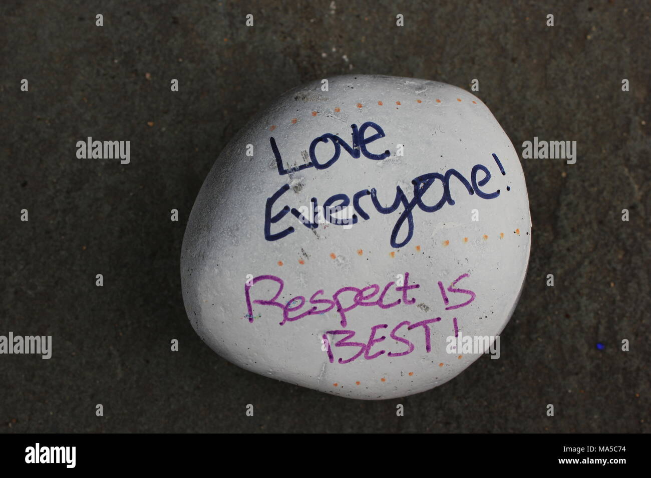 Local street art rock decorated with inspirational slogans "Love ...