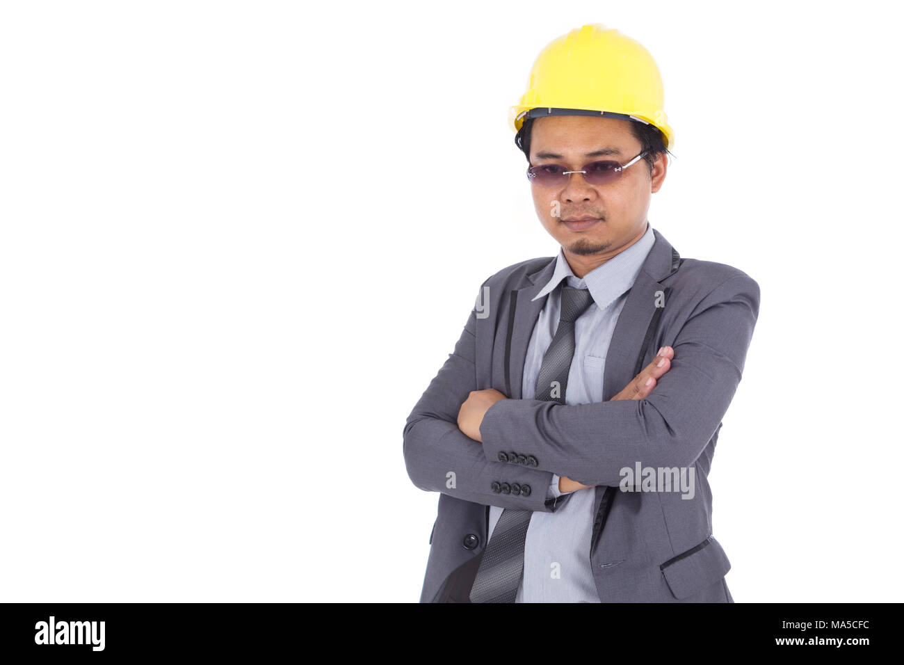 engineer in yellow helmet with arms crossed, isolated on white Stock ...