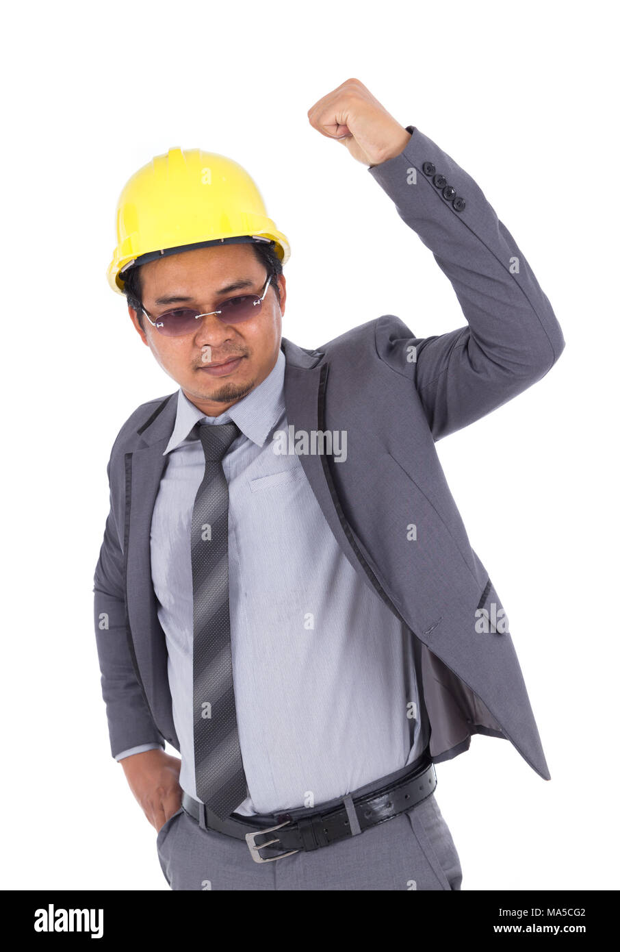 Happy young engineer celebrating with arm raised, concept of successful ...
