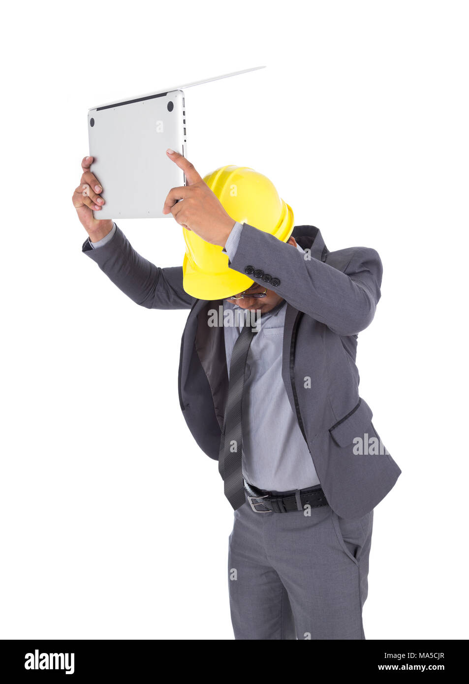 very angry engineer is throwing away his laptop isolated on a white ...
