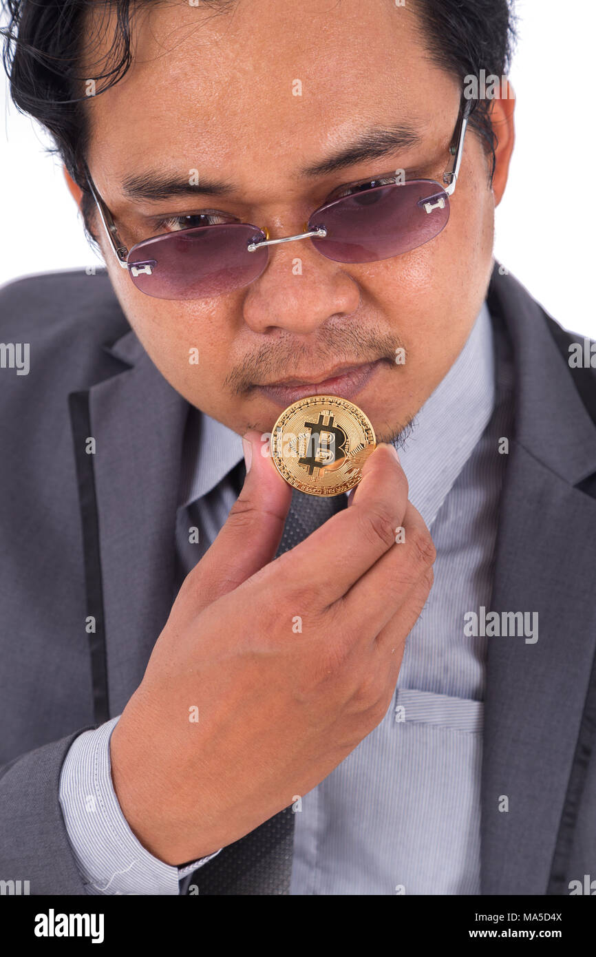 man holding golden bitcoin in hand isolated on a white background Stock ...